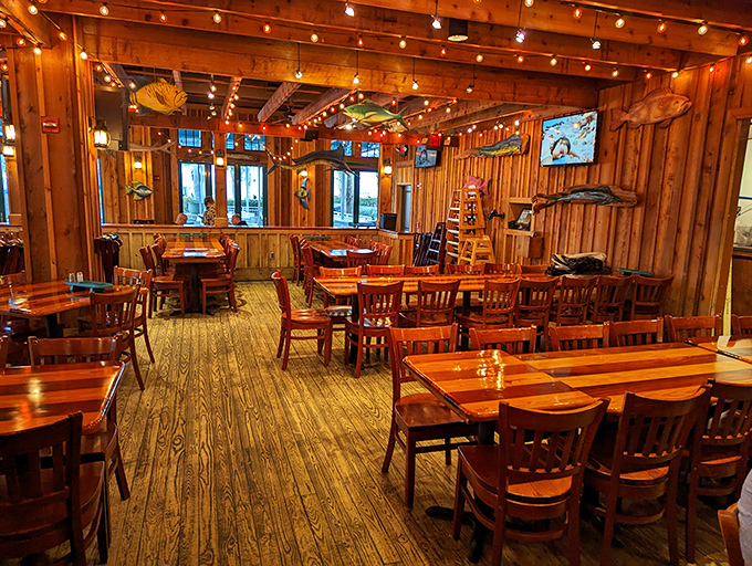 Warm wood, hanging fish, and string lights create the perfect backdrop for seafood stories. It's like dining in the world's coziest fishing cabin.