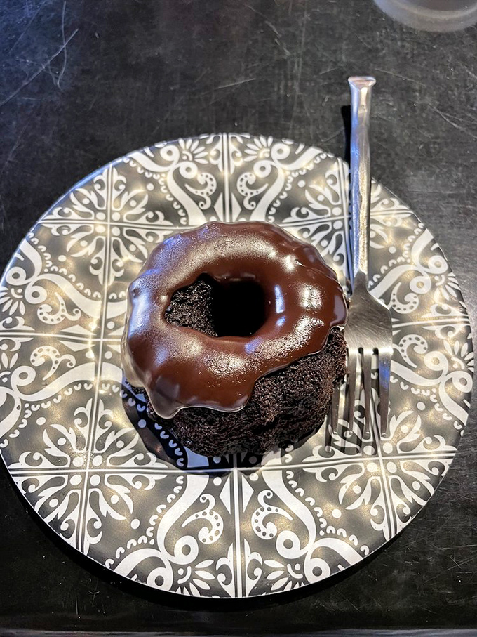 Chocolate donut of destiny! This glossy, ganache-topped wonder sits on a decorative plate like the dessert equivalent of a mic drop&mdash;rich, decadent, and unapologetic.