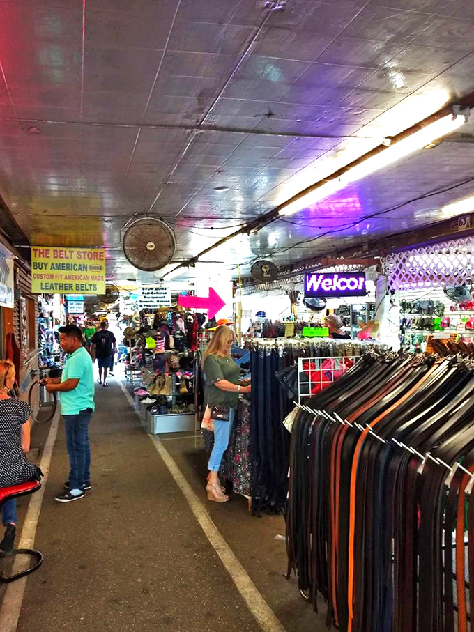 The Belt Store sign promises American-made leather while neon lights beckon shoppers deeper into the labyrinth of potential impulse purchases.