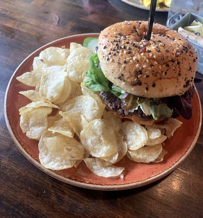 This burger isn't just a meal, it's an event. Surrounded by house-made chips that crunch loud enough to announce your commitment to indulgence.