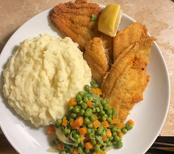 Fried fish so perfectly golden beside those cloud-like mashed potatoes &ndash; a plate that whispers "nap time" even as you reach for another bite.