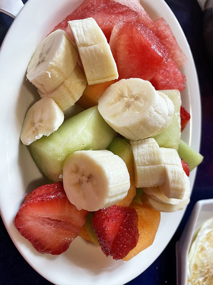 A bowl of fresh fruit that somehow feels both virtuous and indulgent—nature's candy for when you need to balance out those pancakes.