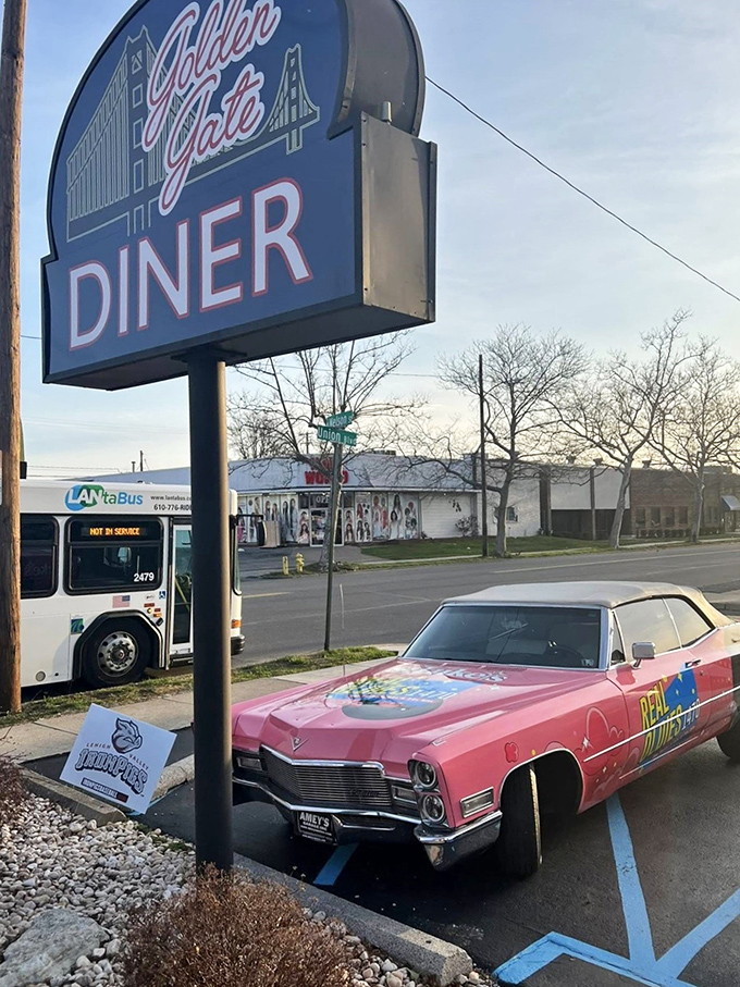That vintage pink Cadillac parked beneath the sign isn't just transportation&mdash;it's a time-traveling chariot waiting to whisk you to an era when diners ruled American cuisine.