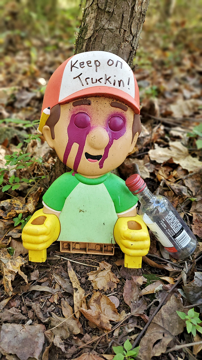 "Keep on Truckin'" indeed! This modified toy with its DIY trucker hat perfectly captures the trail's irreverent, upcycled spirit.