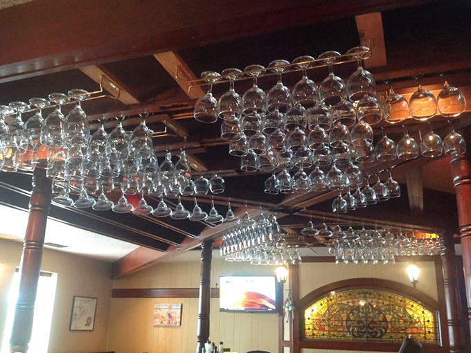 These suspended wine glasses aren't just practical storage&mdash;they're crystal chandeliers waiting to participate in your celebration of exceptional seafood.