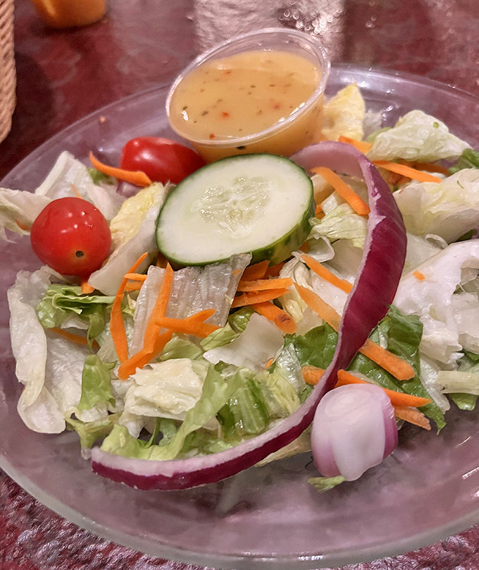 Even the house salad shows up dressed for success, with fresh vegetables providing the opening act before the meaty main event steals the spotlight.