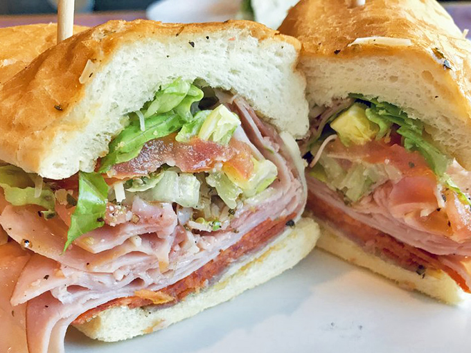 The Italian Cold Cut Sub&mdash;a masterclass in sandwich architecture. Each layer visible in perfect cross-section, like a delicious geological formation of meats and veggies.