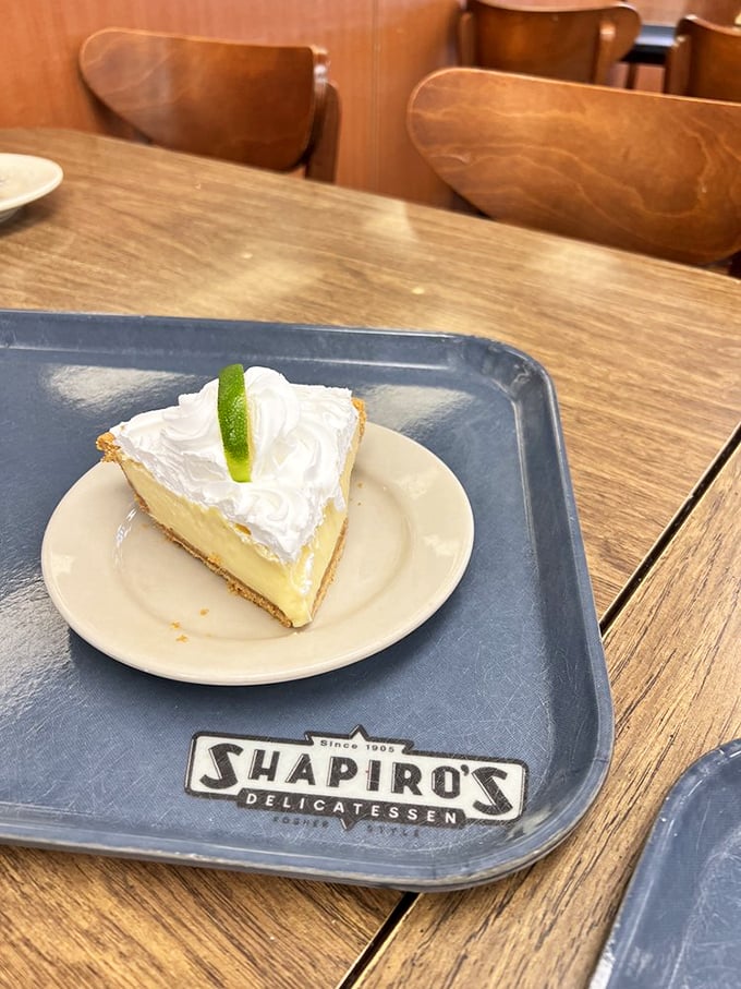 A slice of key lime pie that hits all the right notes: sweet, tart, creamy, with a dollop of whipped cream that's basically a cloud on earth.
