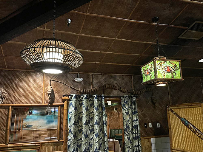 Overhead, custom tiki lamps cast a warm glow that makes everyone look like they've just returned from a Hawaiian vacation.