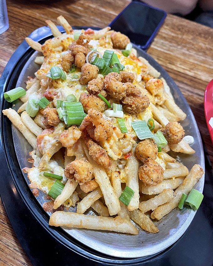 Loaded crab fries that blur the line between appetizer and life-changing experience. Crispy potatoes topped with seafood treasure and melty cheese&mdash;pure Louisiana genius.