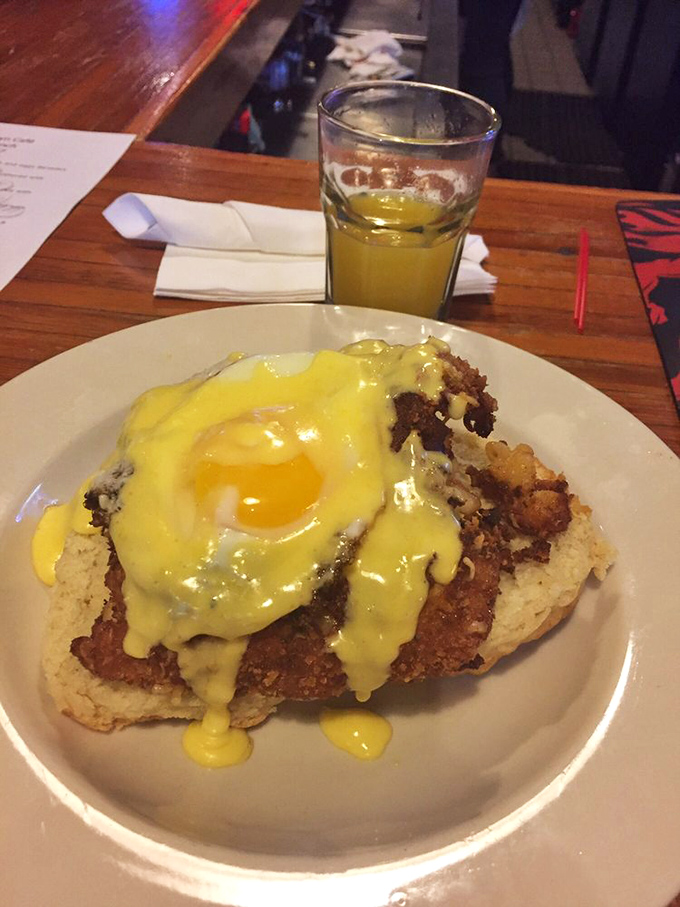 Hollandaise sauce cascading over a perfectly poached egg atop what appears to be a delicious biscuit &ndash; breakfast elevated to an art form.