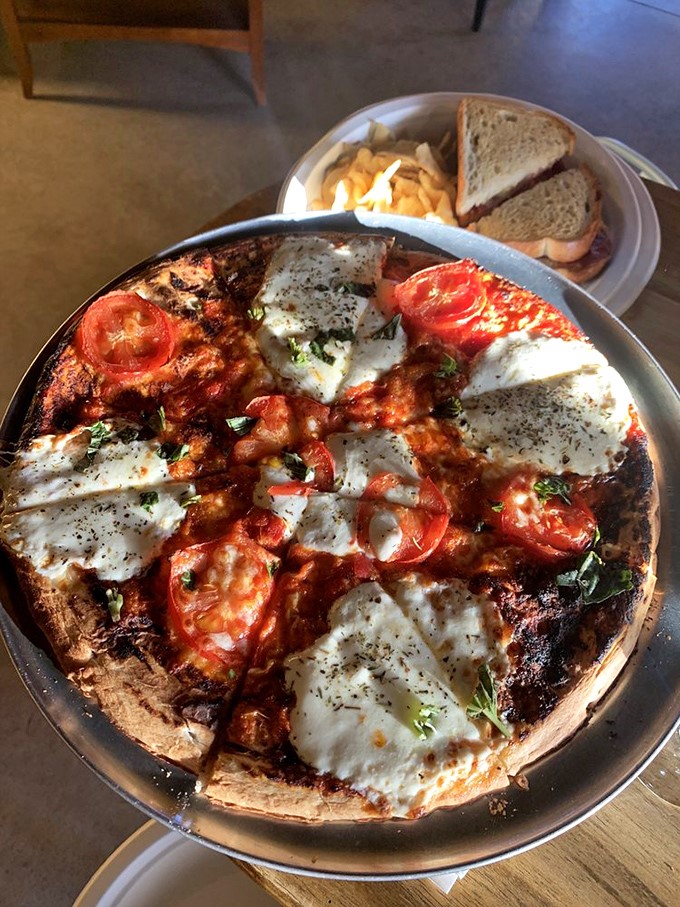 This isn't just pizza&mdash;it's a crispy canvas of melted cheese, garden-fresh tomatoes, and herbs that pairs perfectly with whatever's in your glass.