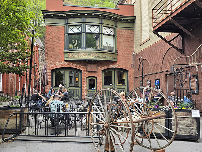 Marion Hose Bar's outdoor seating invites you to linger over drinks. Those wagon wheels aren't just decoration—they're conversation starters.