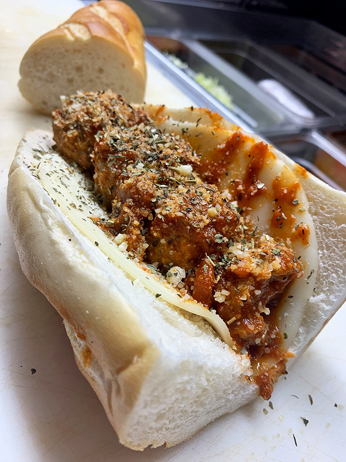 Meatballs basking in sauce and cheese like they're at an Italian spa. The bread is just lucky to be involved in this relationship.