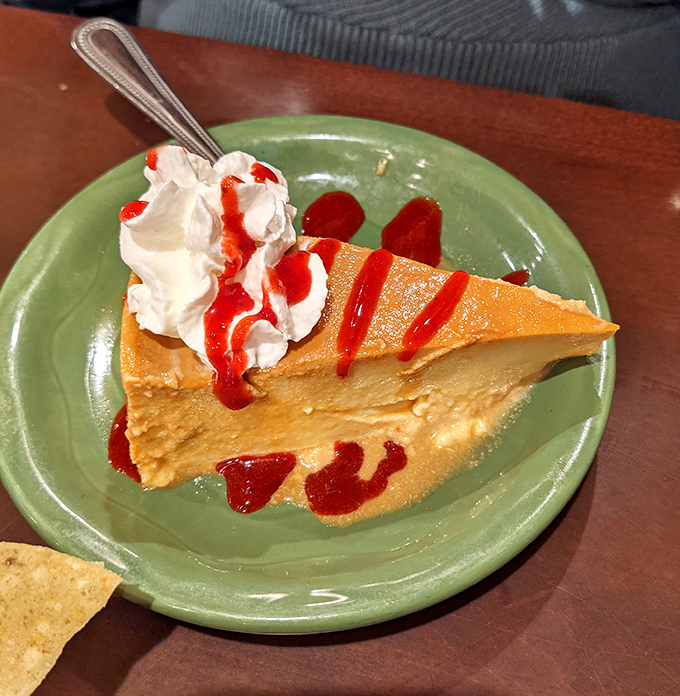 The flan arrives like a silky dream on a green plate. That caramel sauce creates perfect amber rivers across the custard's surface, promising sweetness with every spoonful.