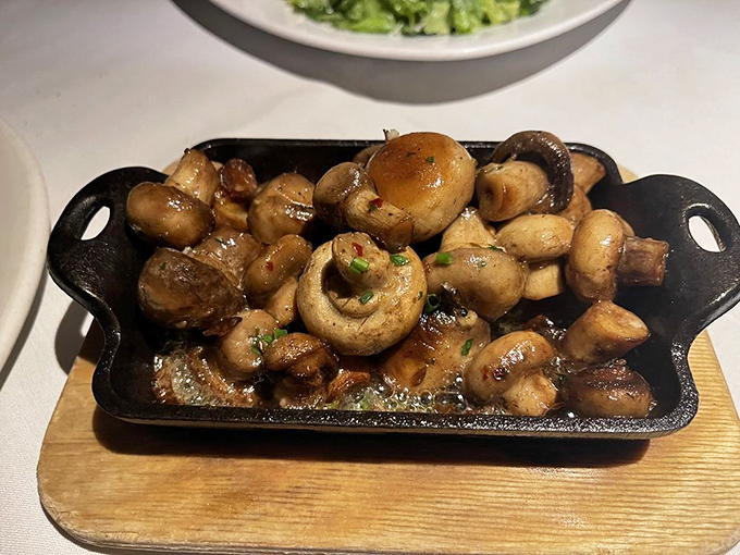 These aren't just mushrooms&mdash;they're little umami bombs, sizzling in their cast iron skillet like they're auditioning for a starring role in your meal.