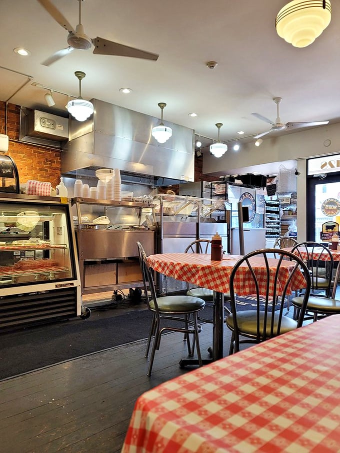 The open kitchen layout means you can watch BBQ magic happen in real-time. Those pendant lights have witnessed countless BBQ epiphanies.