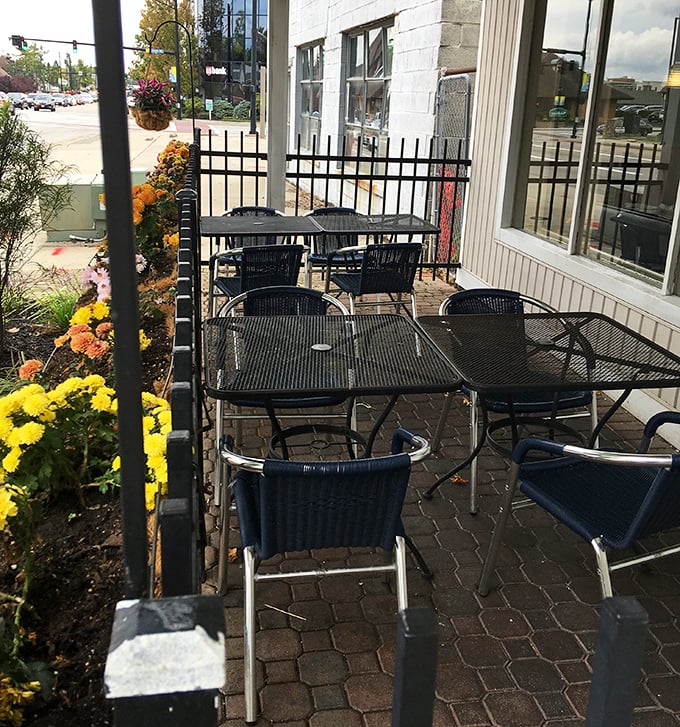 The outdoor patio offers a breath of fresh air with your meal. Those mums add a splash of color, like nature's garnish on your dining experience.