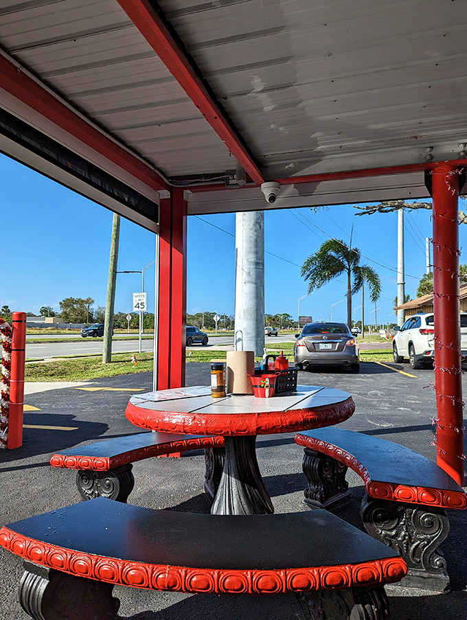 Covered patio seating where Florida breezes complement burger aromas. The perfect spot to enjoy your feast while watching the world drive by