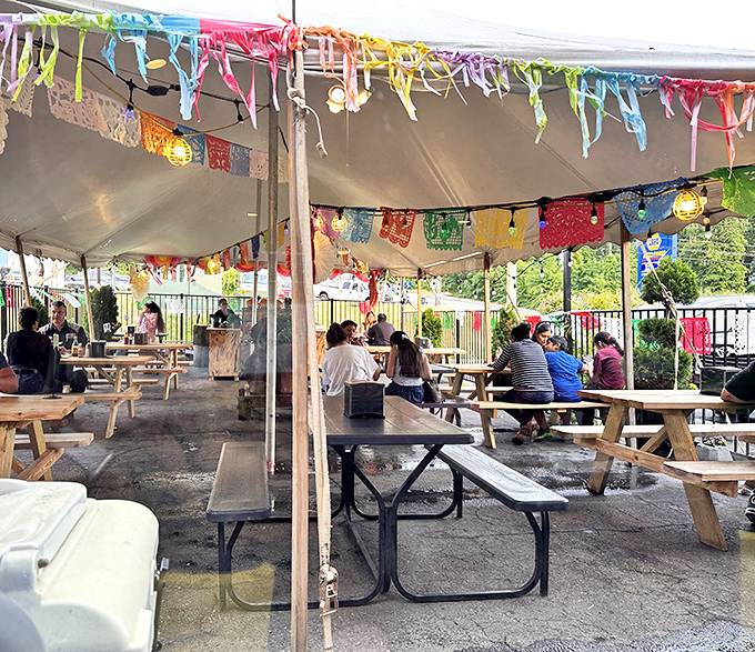 The outdoor seating area feels like a backyard fiesta, where picnic tables and colorful banners invite you to linger over one more taco.