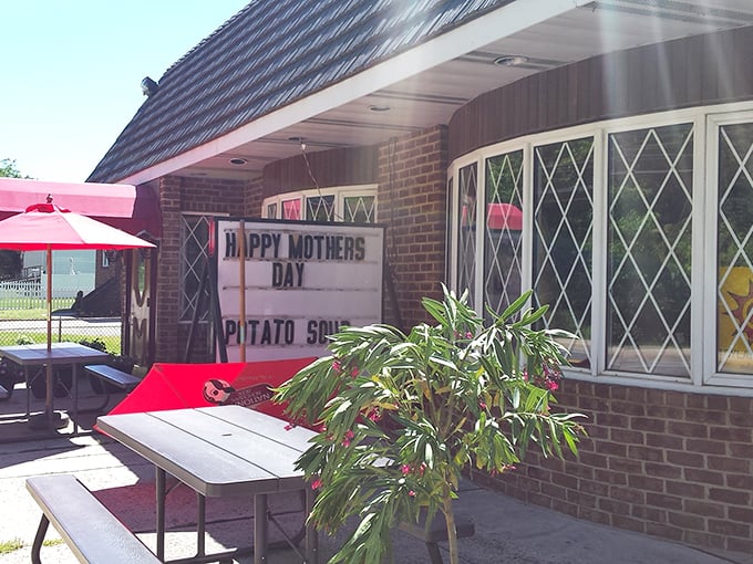 A cozy restaurant with outdoor seating displays a sign reading "Happy Mothers Day" and "Potato Soup," suggesting a special offering for the occasion.