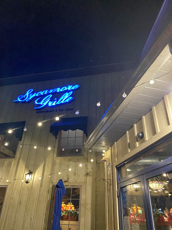 As darkness falls, the blue neon sign becomes a beacon for hungry travelers and locals alike, promising culinary comfort ahead.