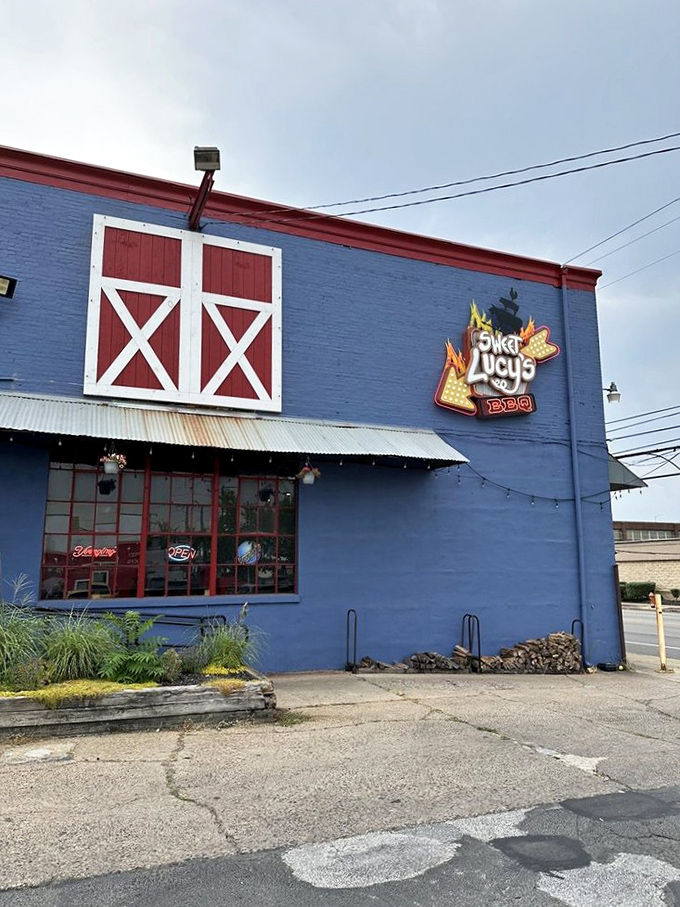 That decorative barn door isn't just for show&mdash;it's foreshadowing the farm-fresh, slow-cooked treasures waiting inside this blue barbecue haven.