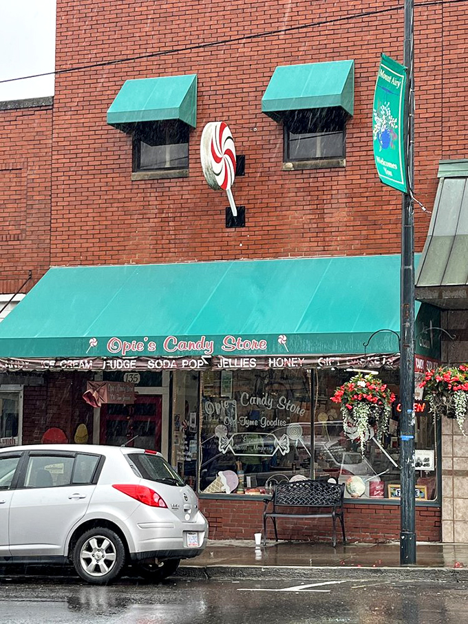 Even on rainy days, that giant lollipop sign and emerald awning shine like a beacon for sweet-toothed travelers seeking shelter from ordinary snacks.