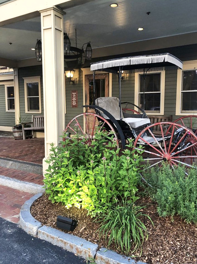 Even the entrance garden tells a story of welcome. That antique carriage isn't just decoration&mdash;it's a time machine to when dining was an unhurried pleasure.