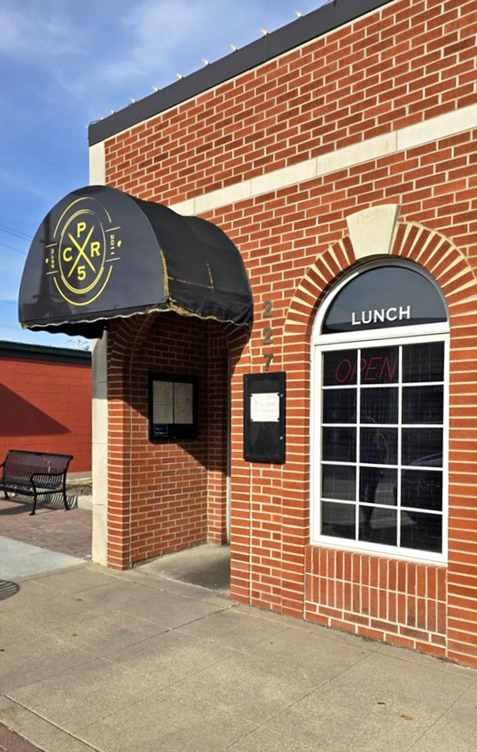 The welcoming exterior with its classic awning signals that serious comfort food and genuine hospitality await inside. 