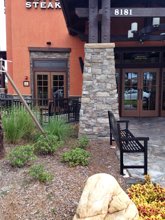 The thoughtful landscaping and stone accents create an entrance that says "yes, we take our steaks seriously" without a hint of pretension.