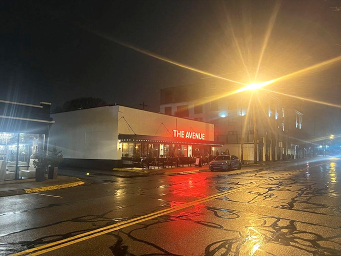 Even in the rain, The Avenue glows with promise. That red sign cuts through the night, guiding hungry souls to carnivorous bliss.