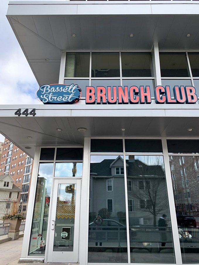 The Bassett Street Brunch Club sign stands proud against Wisconsin skies, like a beacon calling all hungry souls home.