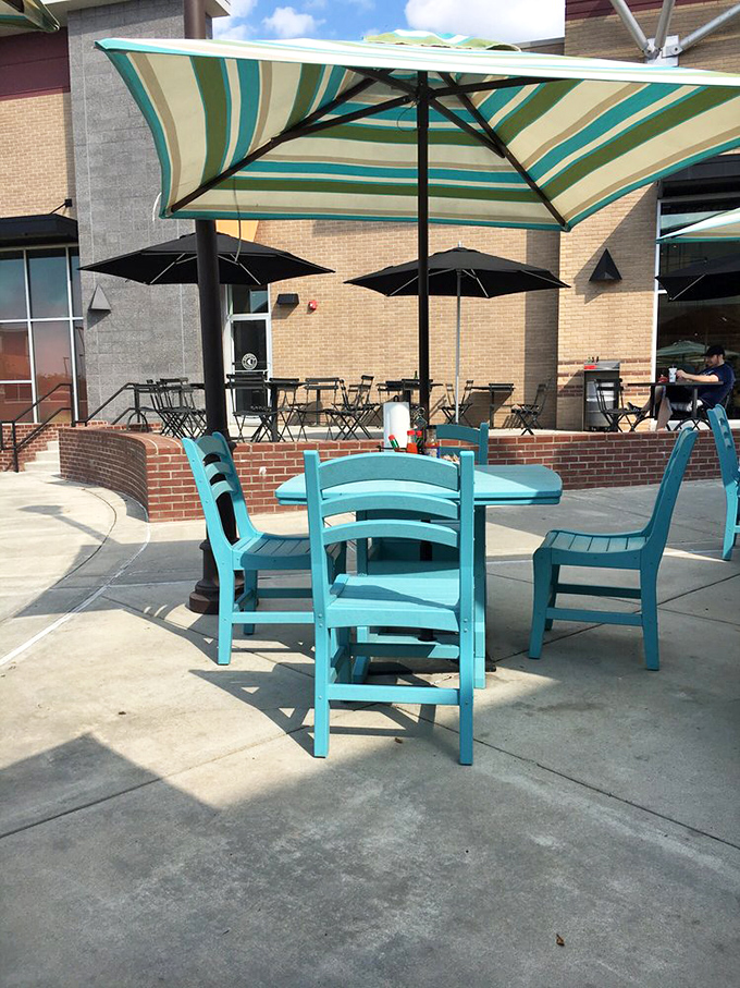 Turquoise chairs under striped umbrellas&mdash;the perfect spot to savor those last bites while plotting your inevitable return.