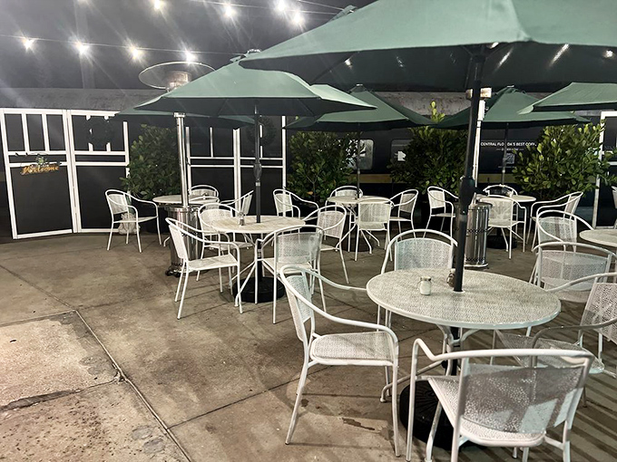 The outdoor seating area transforms into a twinkling oasis after dark&mdash;perfect for enjoying those loaded fries under the stars on a balmy Florida evening.