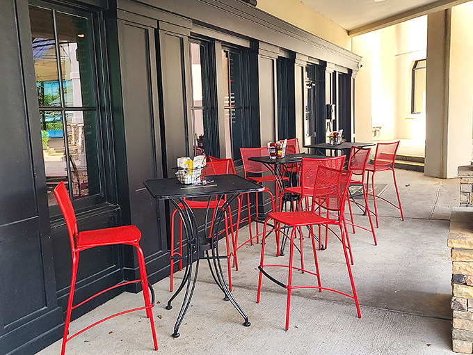 Red chairs pop against black tables on the patio, offering al fresco dining for those perfect Georgia evenings when the humidity takes a rare break.