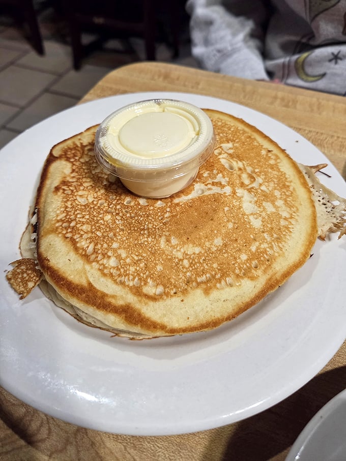 A pancake so perfectly golden it deserves its own Instagram account. That butter cup isn't a garnish&mdash;it's an essential life force.