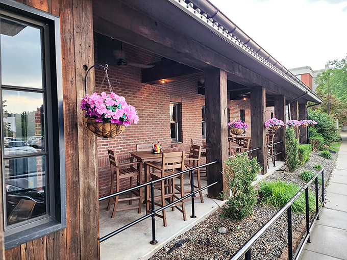 The outdoor patio, with its hanging flower baskets and wooden beams, offers a breath of fresh air that somehow makes those wings taste even better.