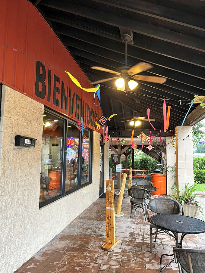 "Bienvenidos" indeed! The festive entrance with colorful streamers sets the tone for the authentic experience waiting just beyond those doors.