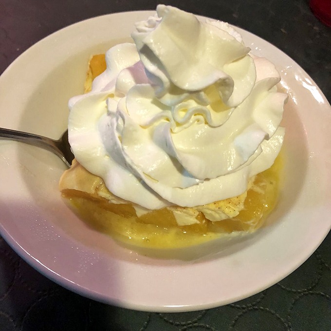 The peach kuchen topped with whipped cream isn't just dessert&mdash;it's the sweet finale to a meal that feels like coming home.