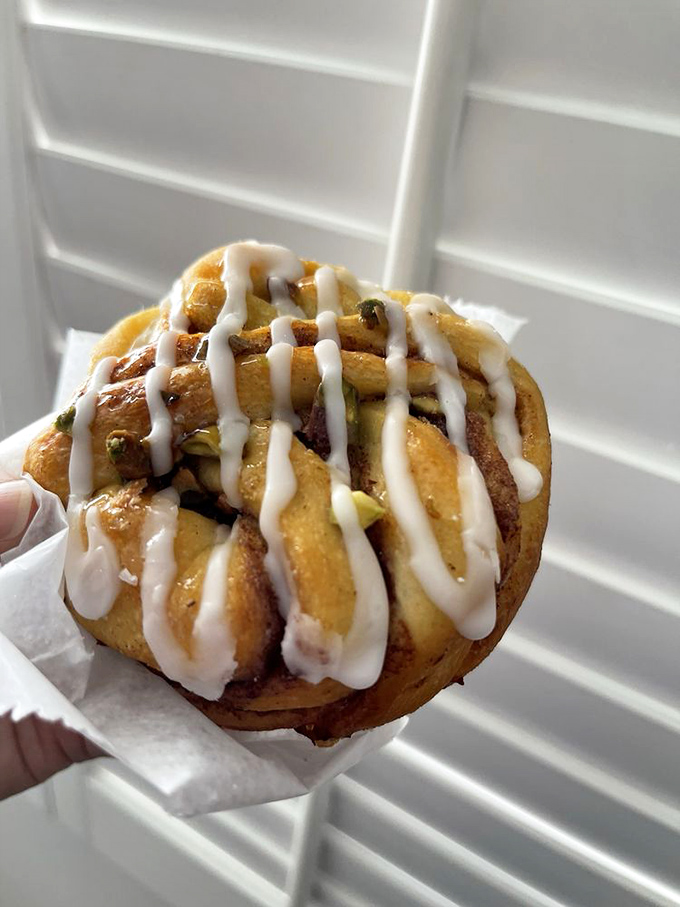 A pistachio cinnamon roll that's dressed better than most people at fashion week. Those vanilla drizzles aren't just decoration&mdash;they're edible exclamation points.