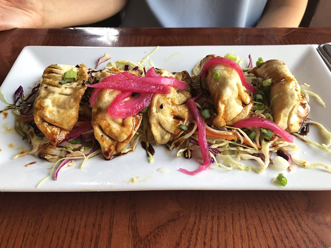 These pot stickers aren't just folded&mdash;they're lovingly crimped into perfect pockets of flavor, resting on a bed of slaw that adds crunch and color.