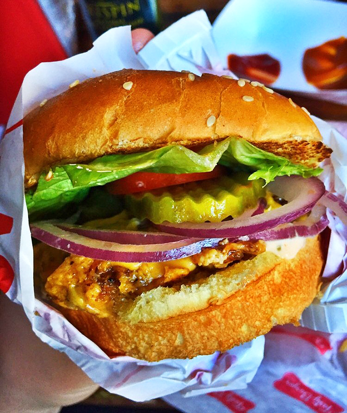 A burger that demands a two-handed commitment and possibly a strategy session before the first bite. Some mountains are worth climbing.