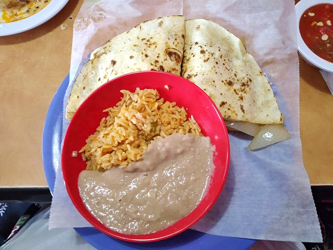 The holy trinity of Mexican comfort: a quesadilla with perfectly melted cheese, seasoned rice, and refried beans that could make a convert of anyone.