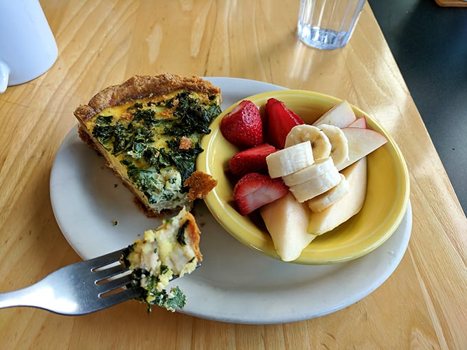 A slice of quiche alongside fresh fruit&mdash;the culinary equivalent of business on top, party on the bottom. Sophistication meets joy.