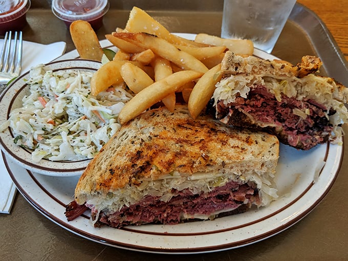 The full Reuben experience: sandwich, sides, and the inevitable food coma that follows. Worth every minute of the post-lunch nap you'll need.