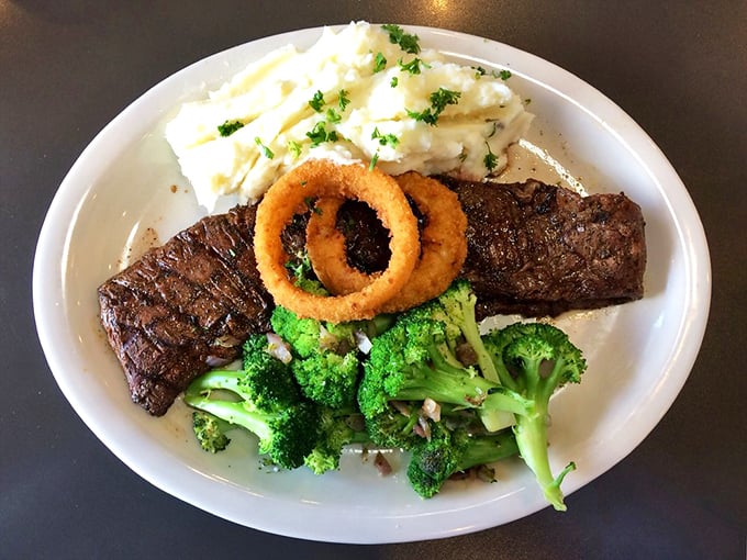 A steak that's lived an interesting life, now resting gloriously beside fluffy mashed potatoes and crisp onion rings&mdash;the holy trinity of diner perfection.
