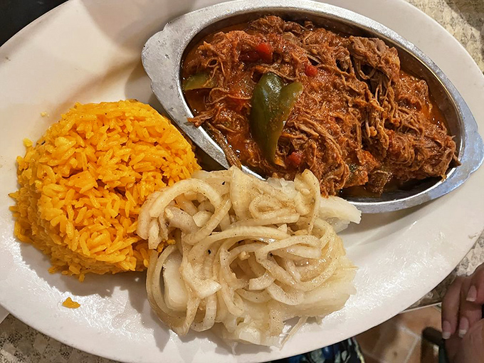 Ropa vieja—literally "old clothes," figuratively "heaven." Shredded beef in tomato sauce with such depth of flavor it deserves its own biography.