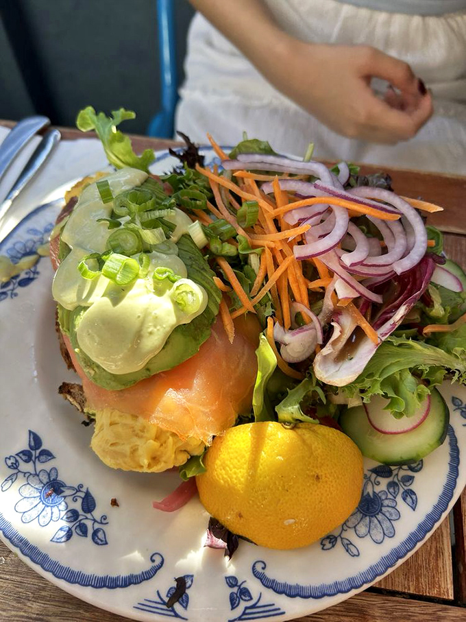 This isn't just a salmon sandwich; it's edible architecture where each colorful layer builds toward breakfast nirvana.