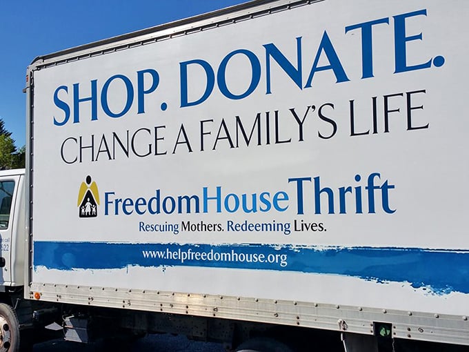 "Shop. Donate. Change a Family's Life." This delivery truck isn't just hauling furniture—it's carrying second chances and new beginnings.